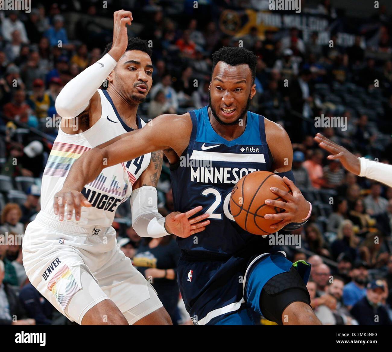 Minnesota Timberwolves guard Josh Okogie, right, drives the lane past ...