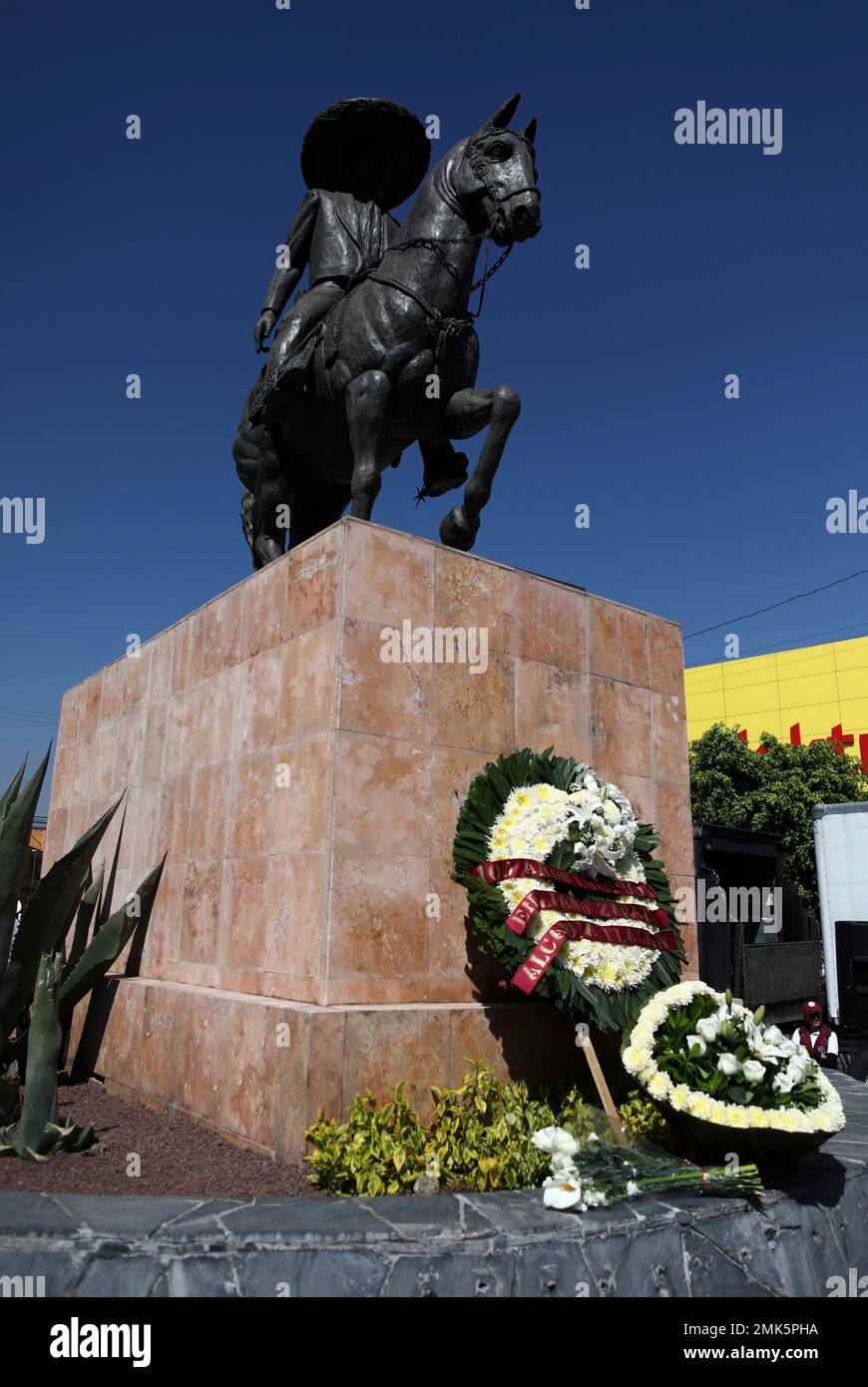 A funeral wreath stands at the base of a statue of Mexican ...