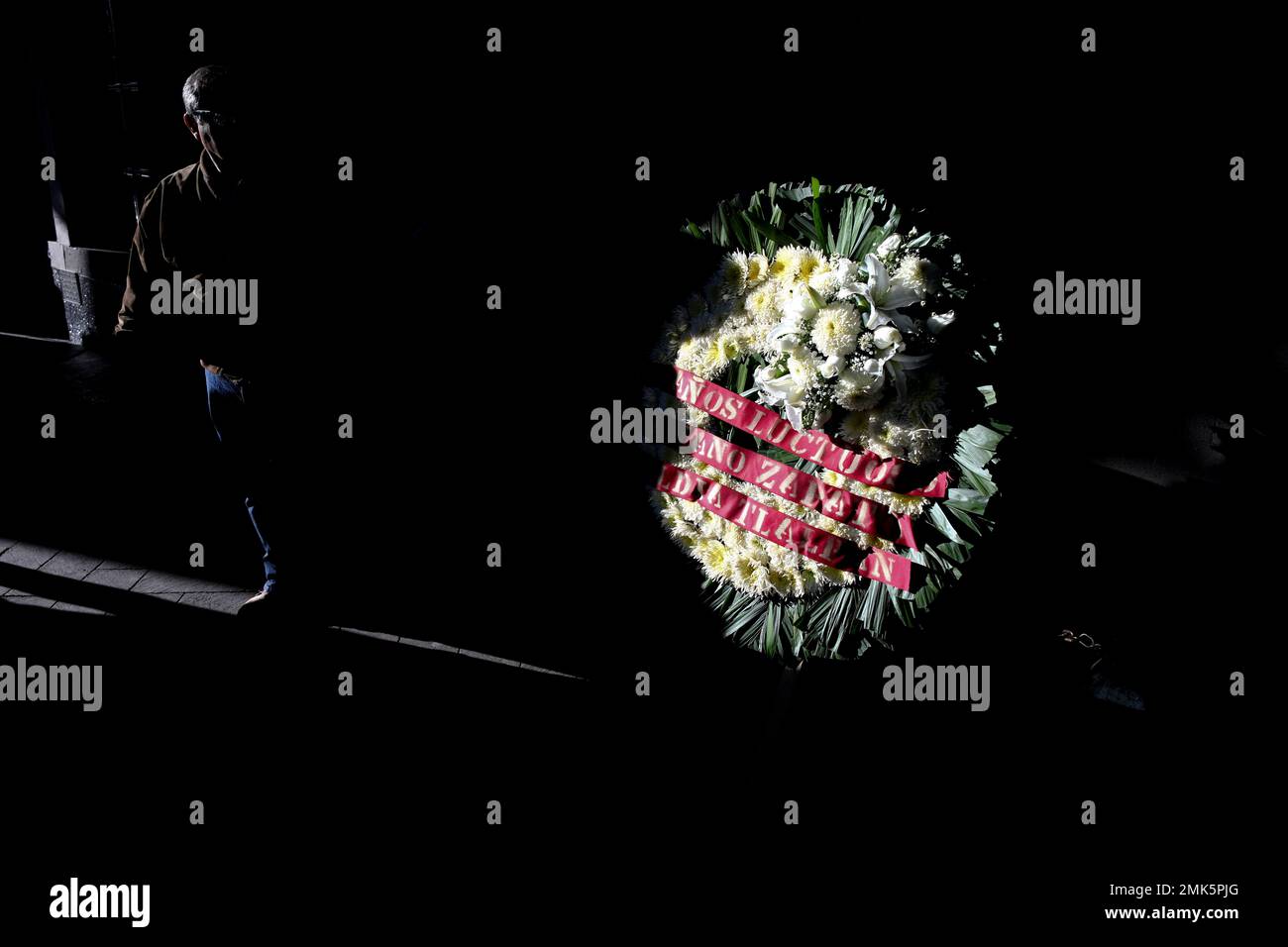 A funeral wreath is illuminated near a statue of Mexican revolutionary ...