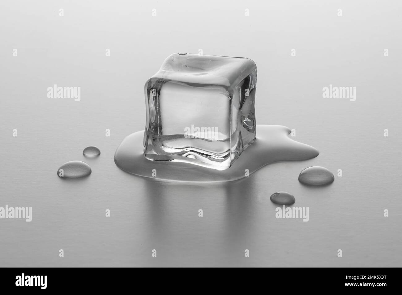cube of melting ice Stock Photo - Alamy