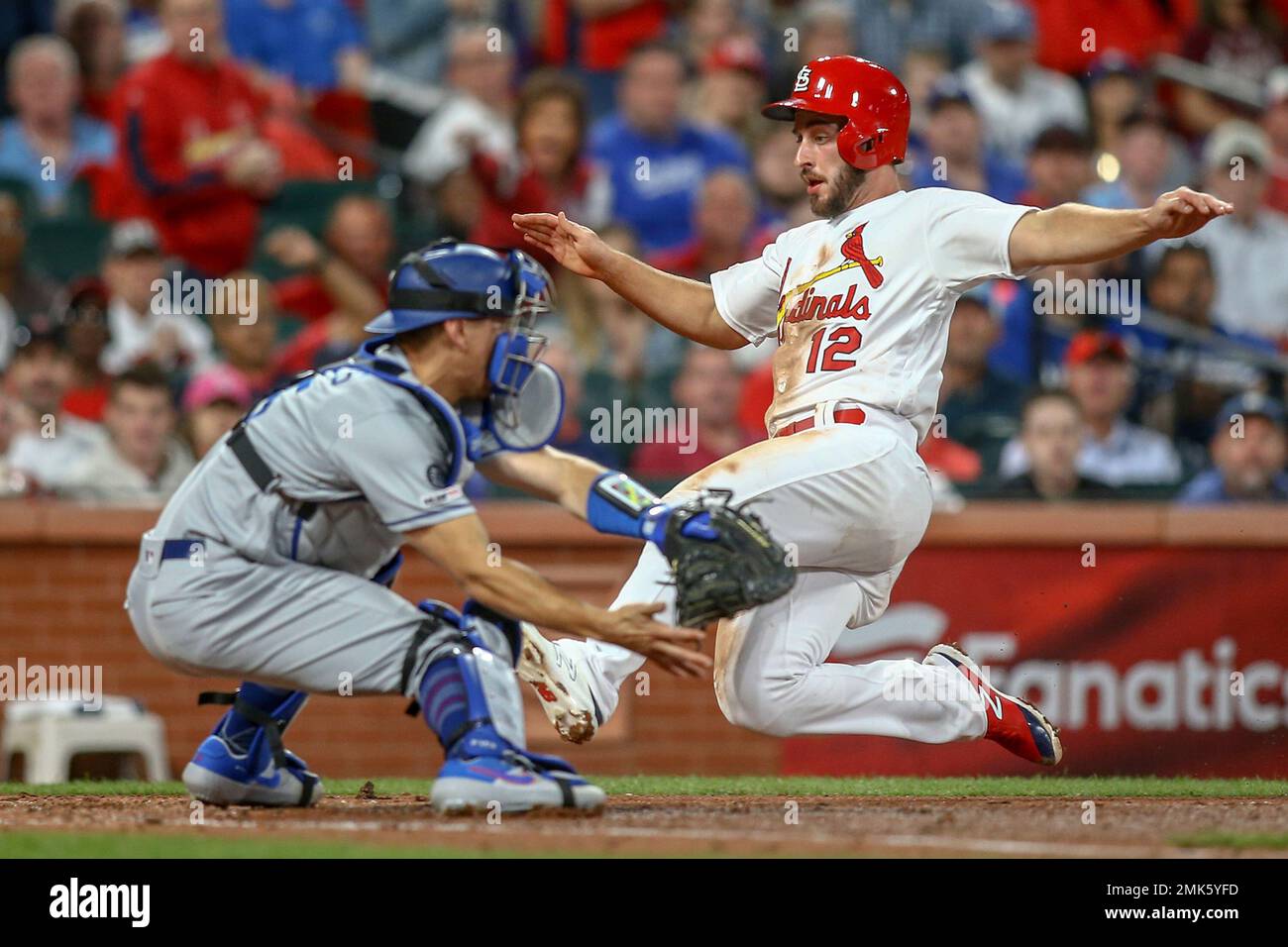 St. Louis Cardinals' Paul DeJong (12) slides home to score next to Los ...