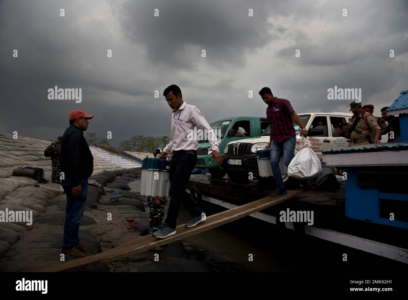 Indian election officials arrive with election material on a ferry ...
