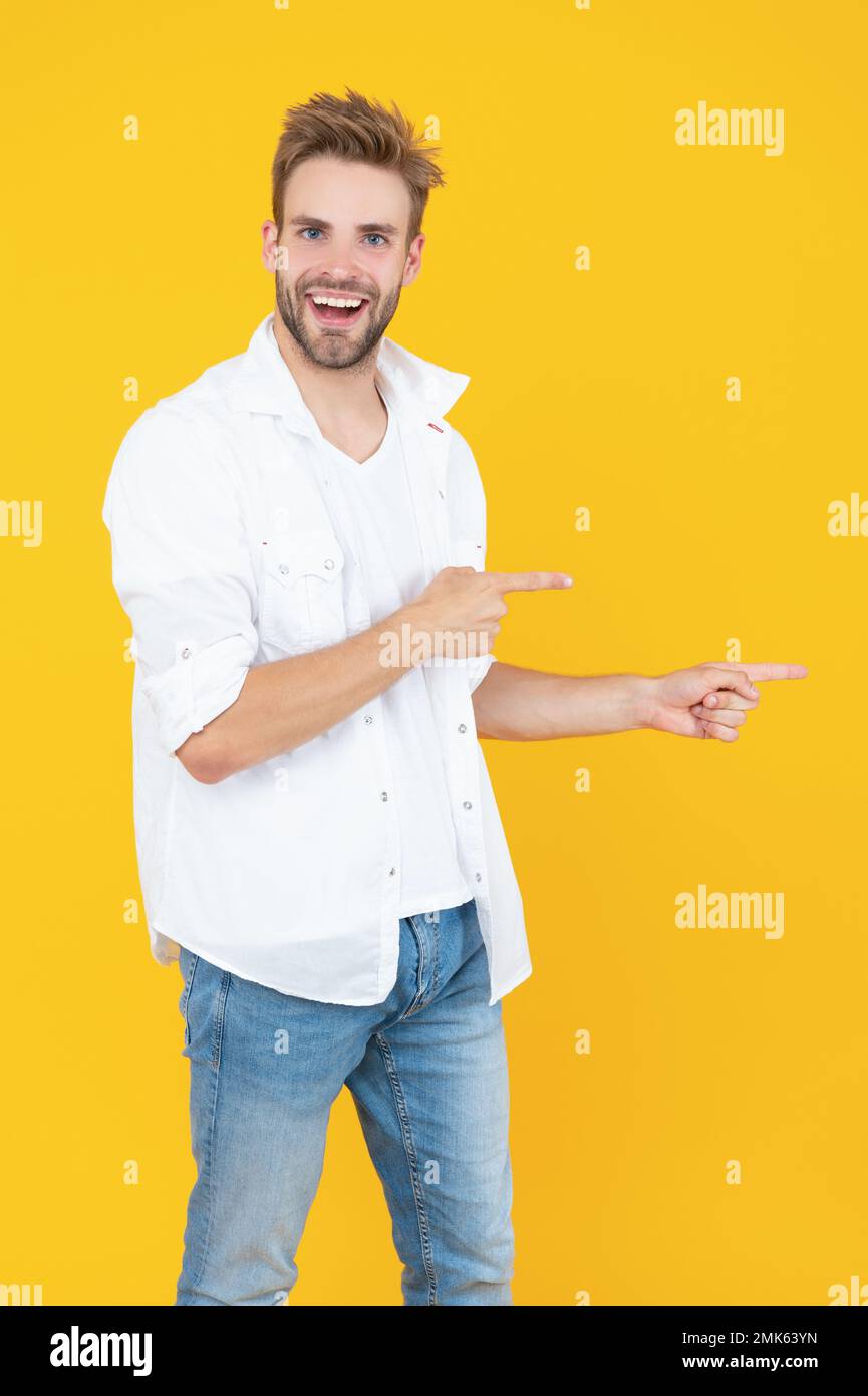 handsome man with stubble on background, pointing finger. photo of ...