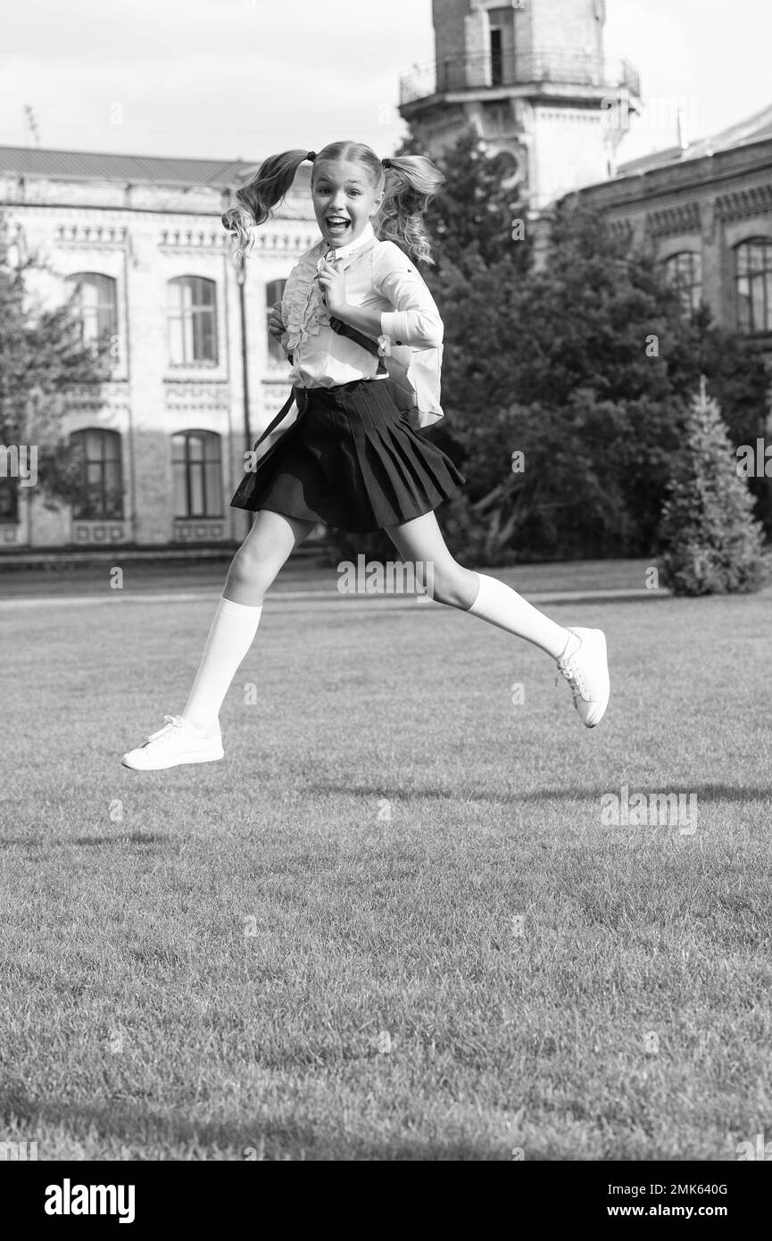 Happy ecstatic kid in uniform back to school jumping for joy, September ...