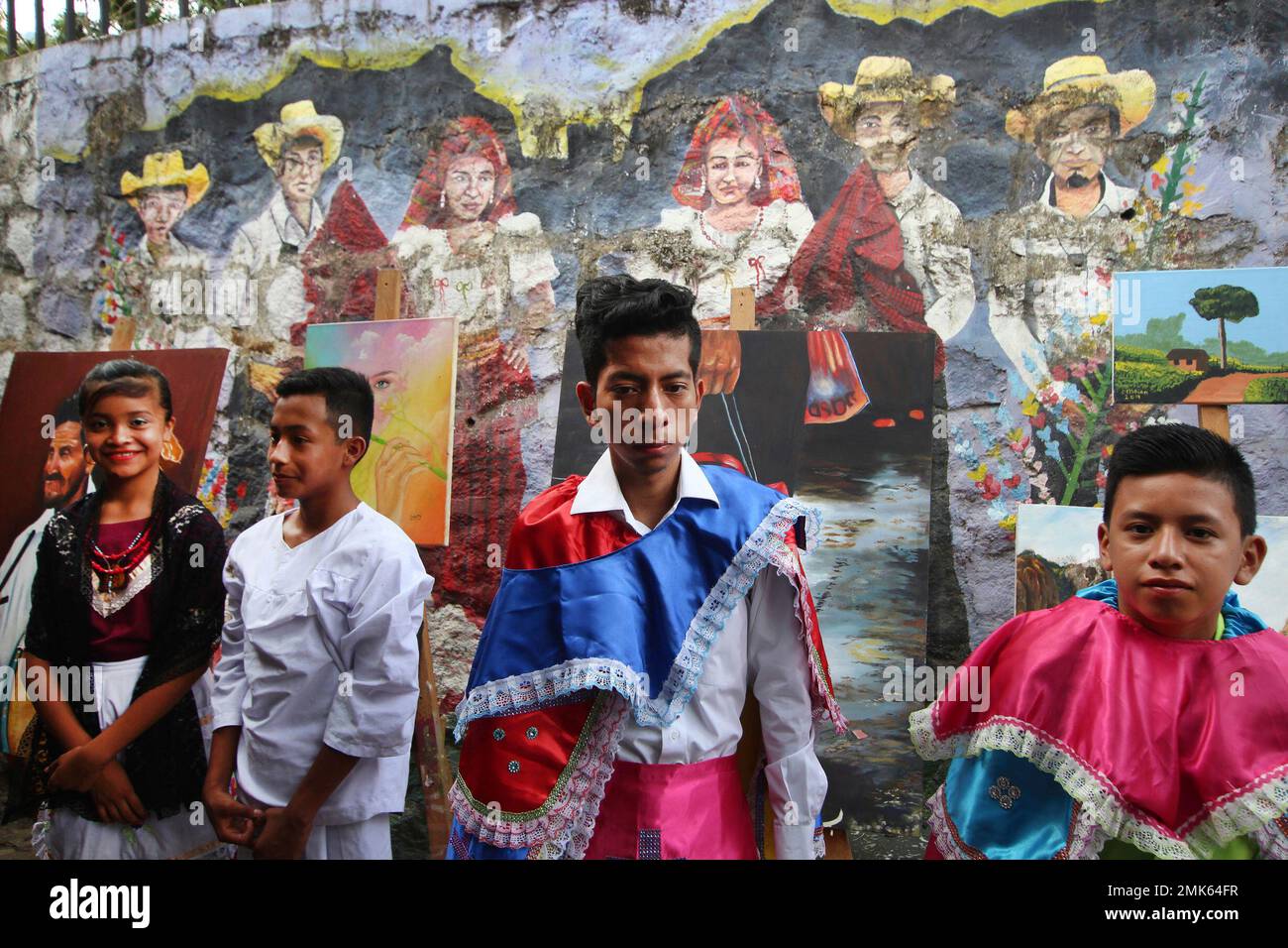 Young Salvadorans wearing traditional costumes listen to California ...