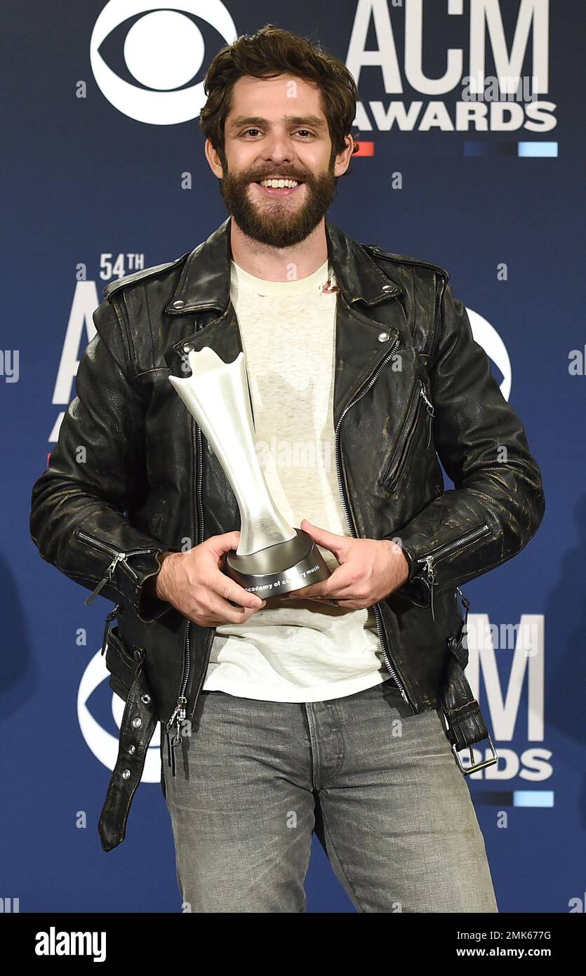Thomas Rhett poses in the press room with the award for male artist of ...