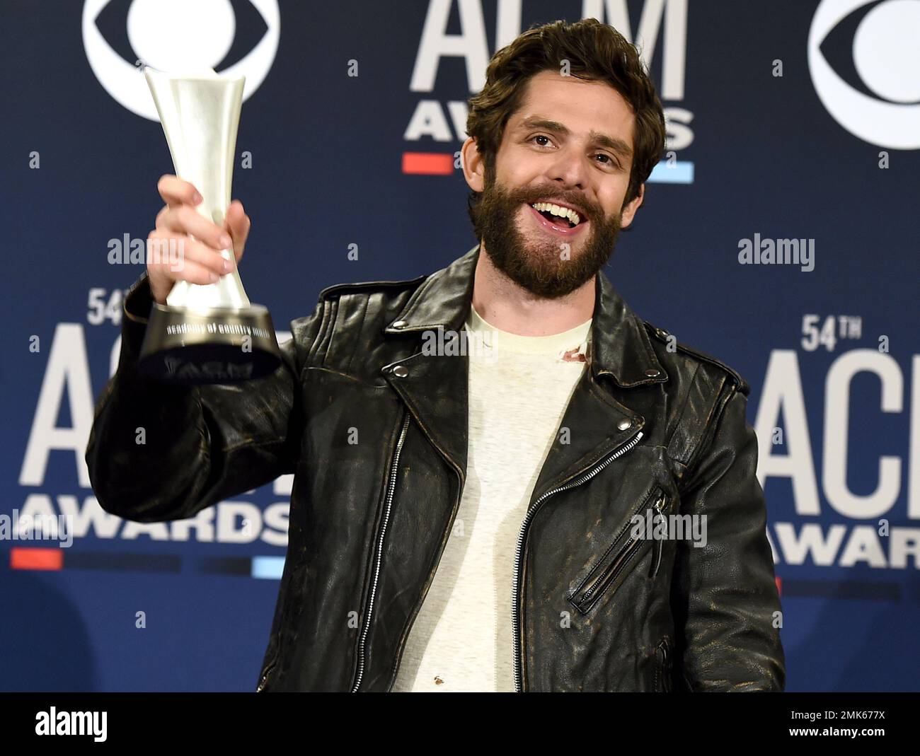 Thomas Rhett poses in the press room with the award for male artist of ...