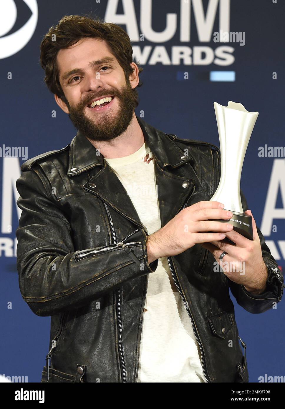 Thomas Rhett poses in the press room with the award for male artist of ...