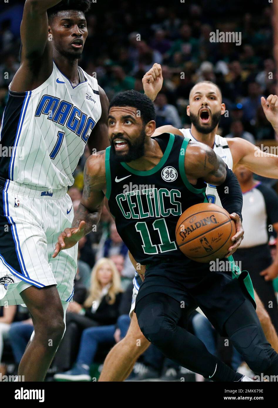 Boston Celtics' Kyrie Irving (11) drives past Orlando Magic's Jonathan ...