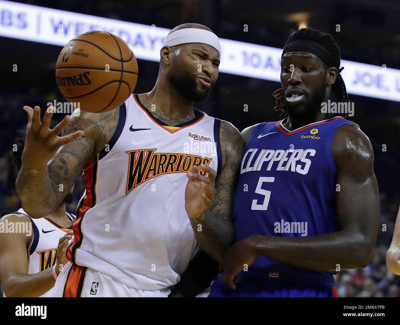Golden State Warriors' DeMarcus Cousins, left, reacts to a foul called ...
