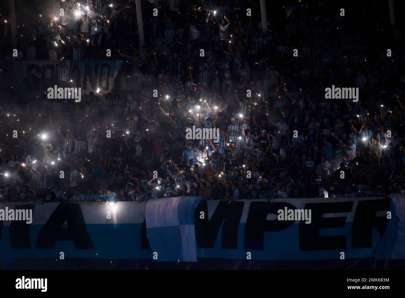 Racing Club fans light flares in the stands during a local tournament ...