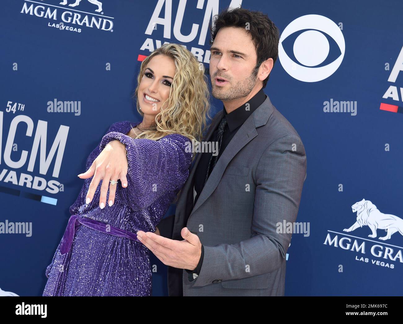Chuck Wicks, right, and Kasi Williams show off an engagement ring as ...