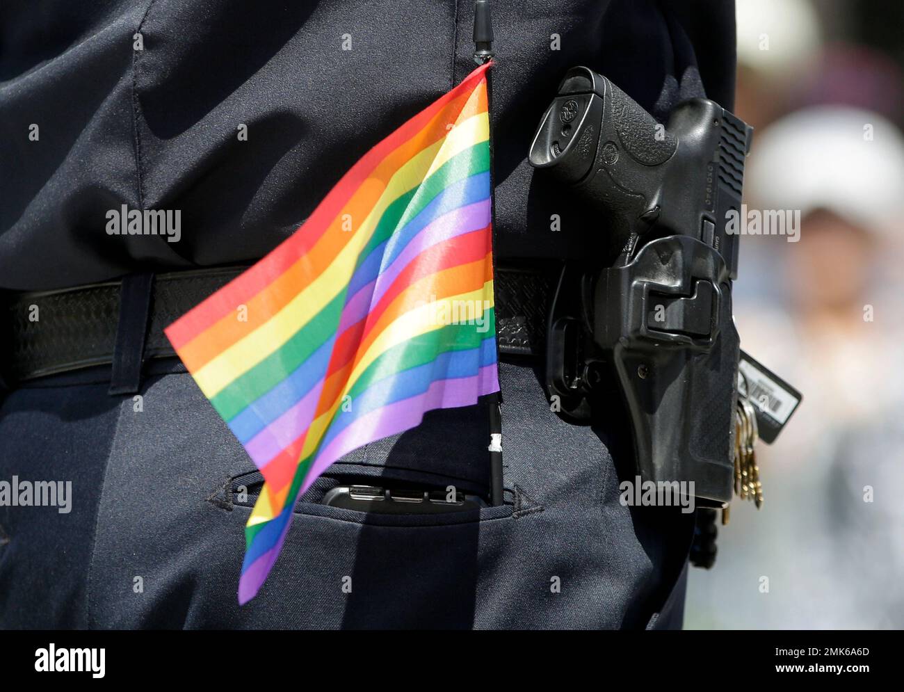 A Miami Beach police officer has a rainbow flag in his pocket during ...