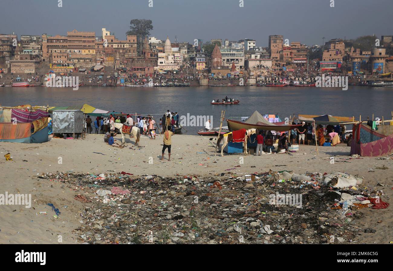 In this March 22, 2019, photo, trash is strewn on the banks of river ...