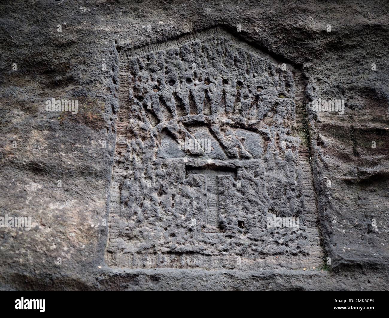 The letter T and the kings crown. Rock relief and engraving in chalk ...