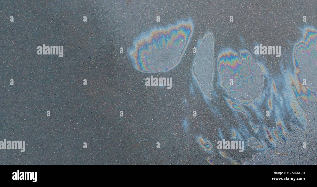 Iridescent spot of gasoline. Petrol on the asphalt a big polluted ...