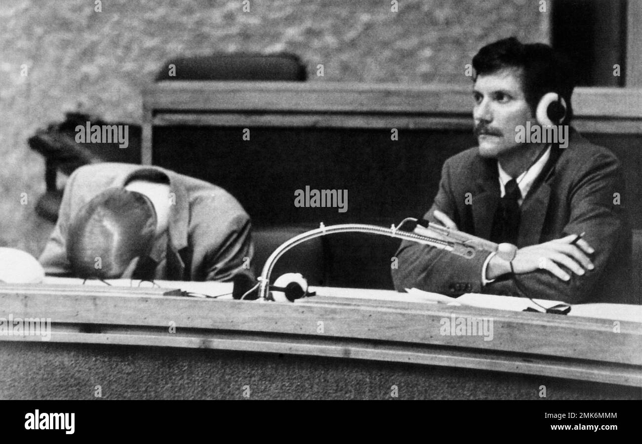 Paul Wolf, left, bows his head as a tape recording that prosecutors ...