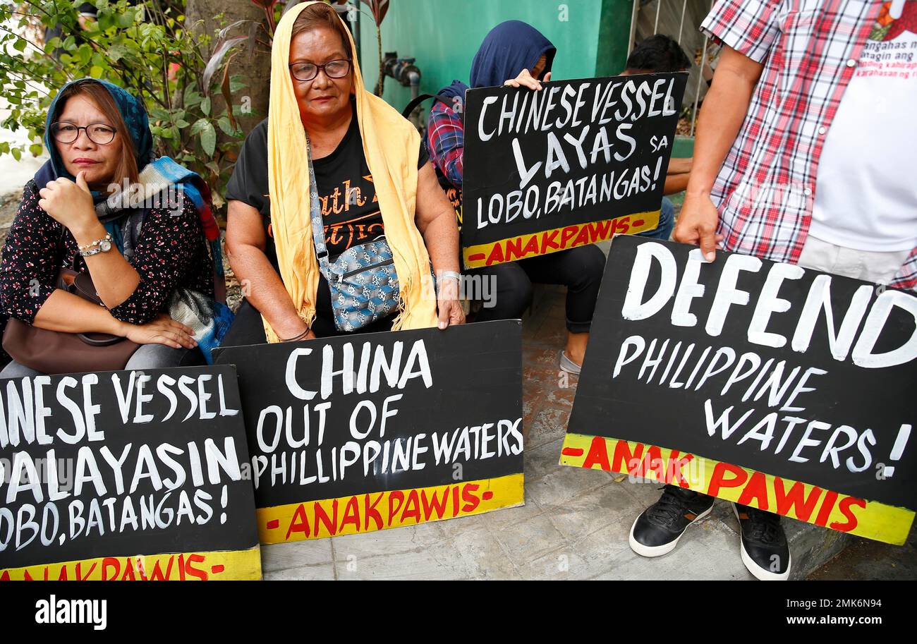 Environmental activists display placards as they picket the Department ...