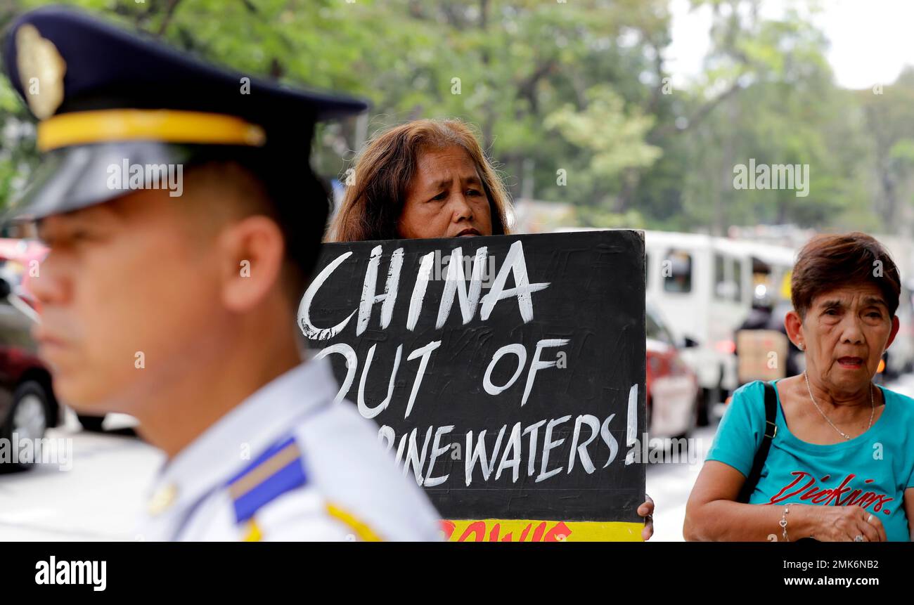 Environmental activists display placards as they picket the Department ...