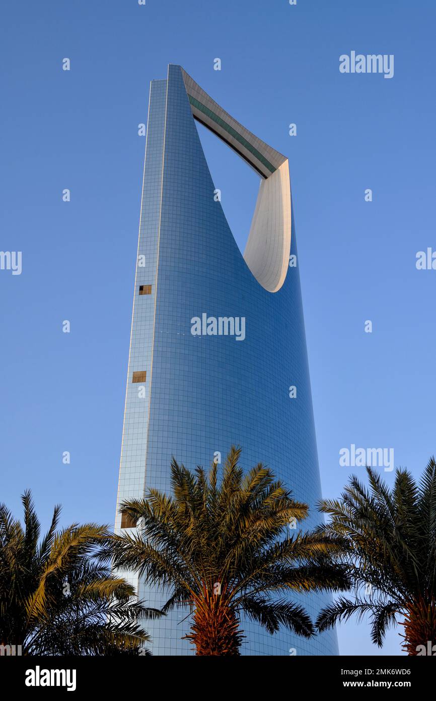 Palm trees in front of the mirrored facade of the Kingdom Center ...