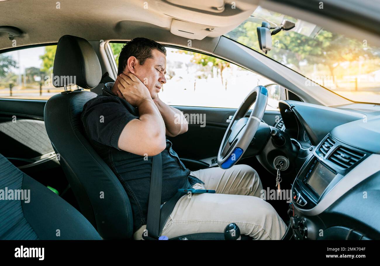 Exhausted driver with neck pain in traffic, Driver people with neck ...