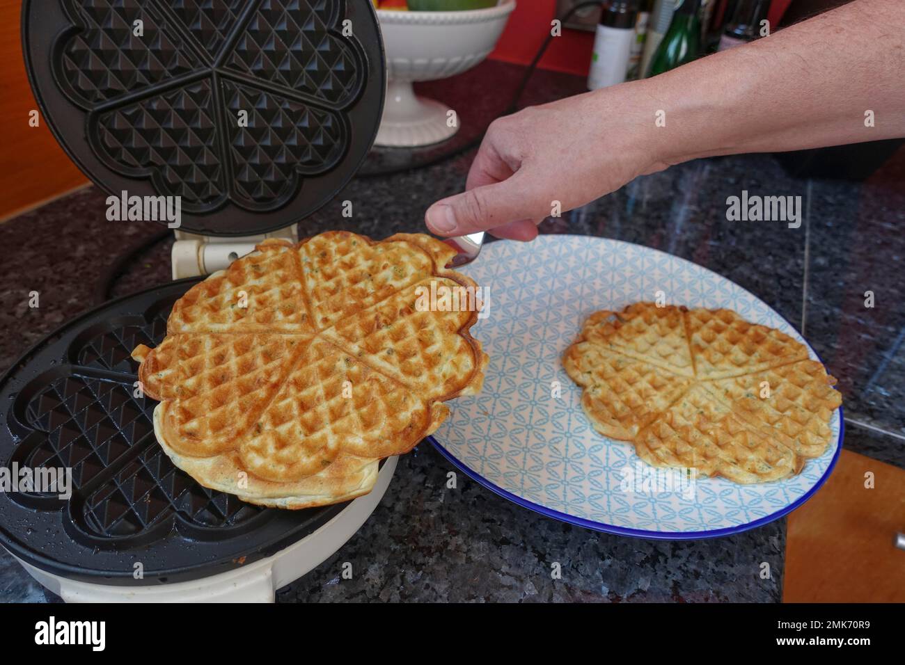 Southern German cuisine, preparation waffles, waffle iron, man's hand ...
