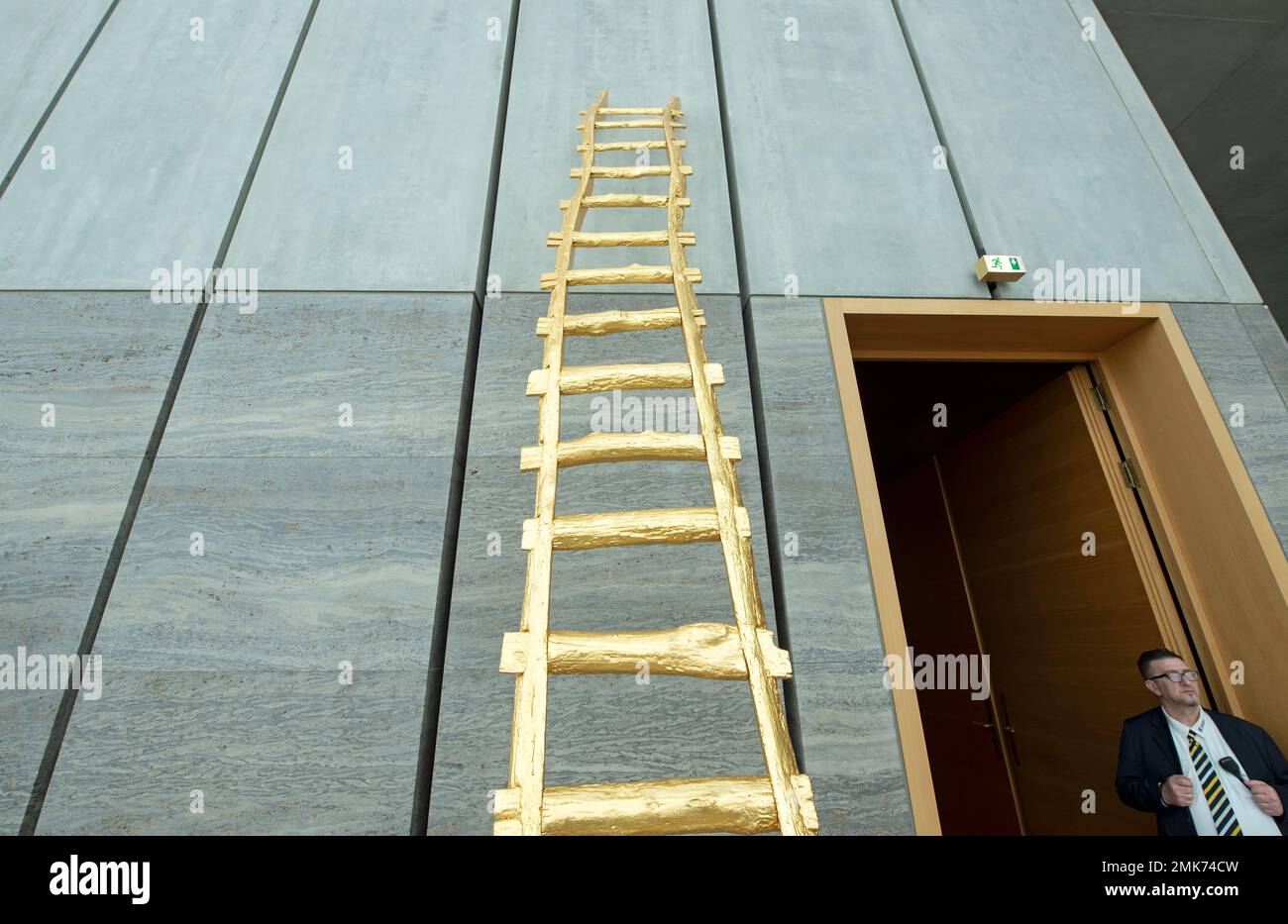 A securitiy officer stands next to the work 'Golden Ladders' (2014/2015 ...