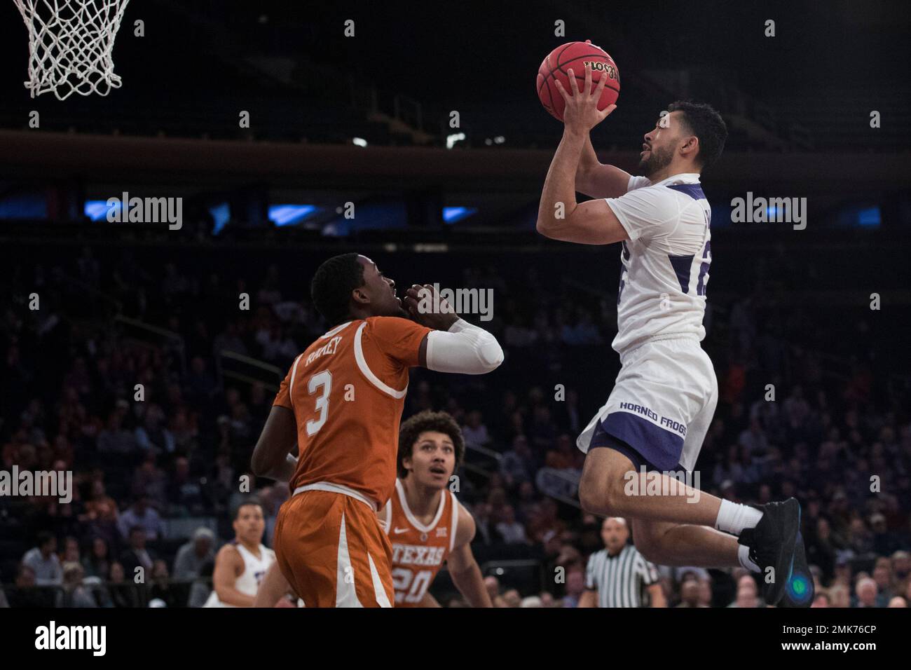 TCU guard Alex Robinson, right, goes to the basket against Texas guard ...