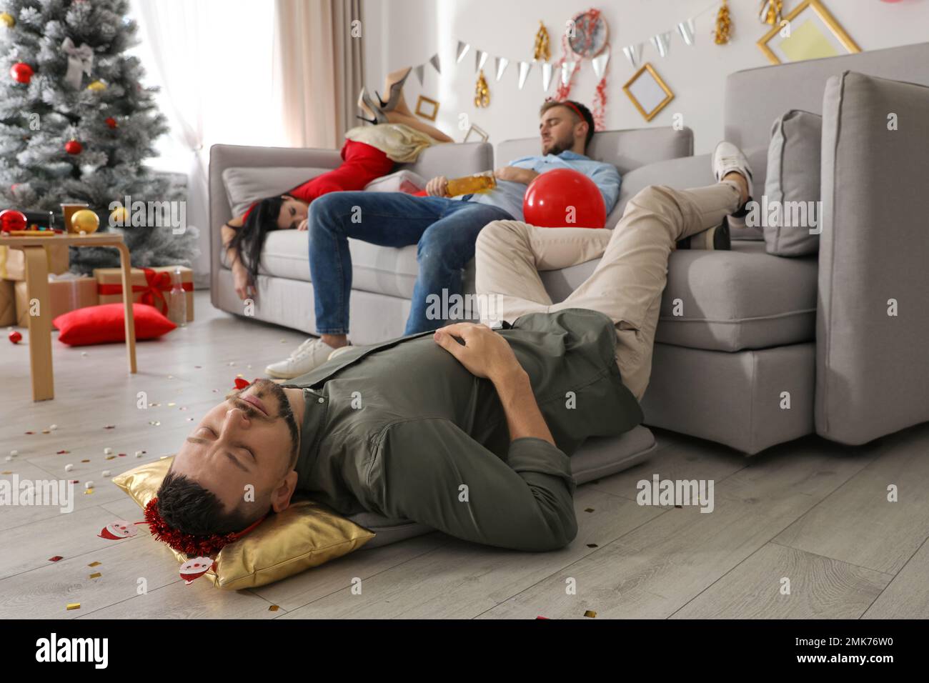 Drunk friends sleeping in messy room after New Year party Stock Photo ...