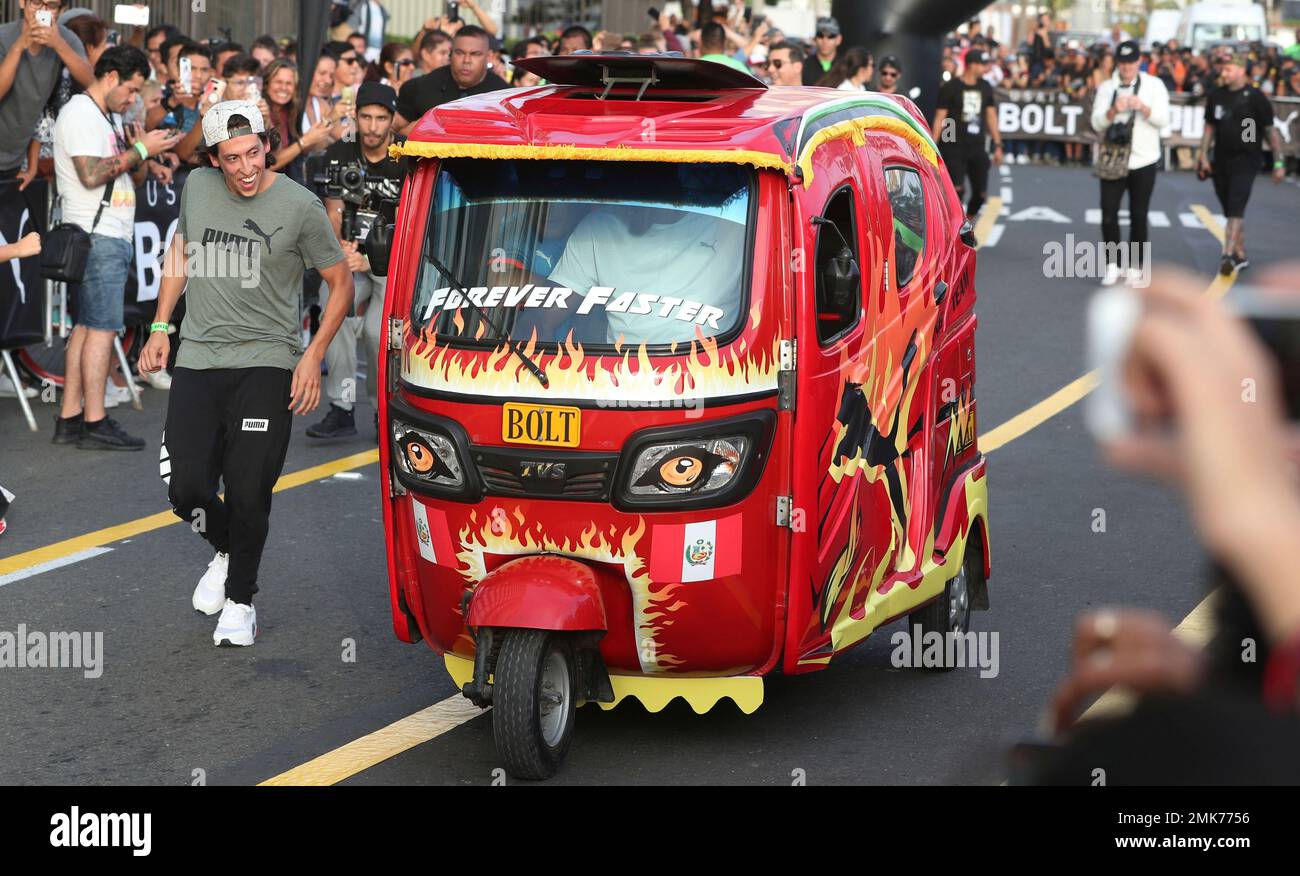 Jamaican sprinter Usain Bolt drives a mototaxi, after defeating the ...