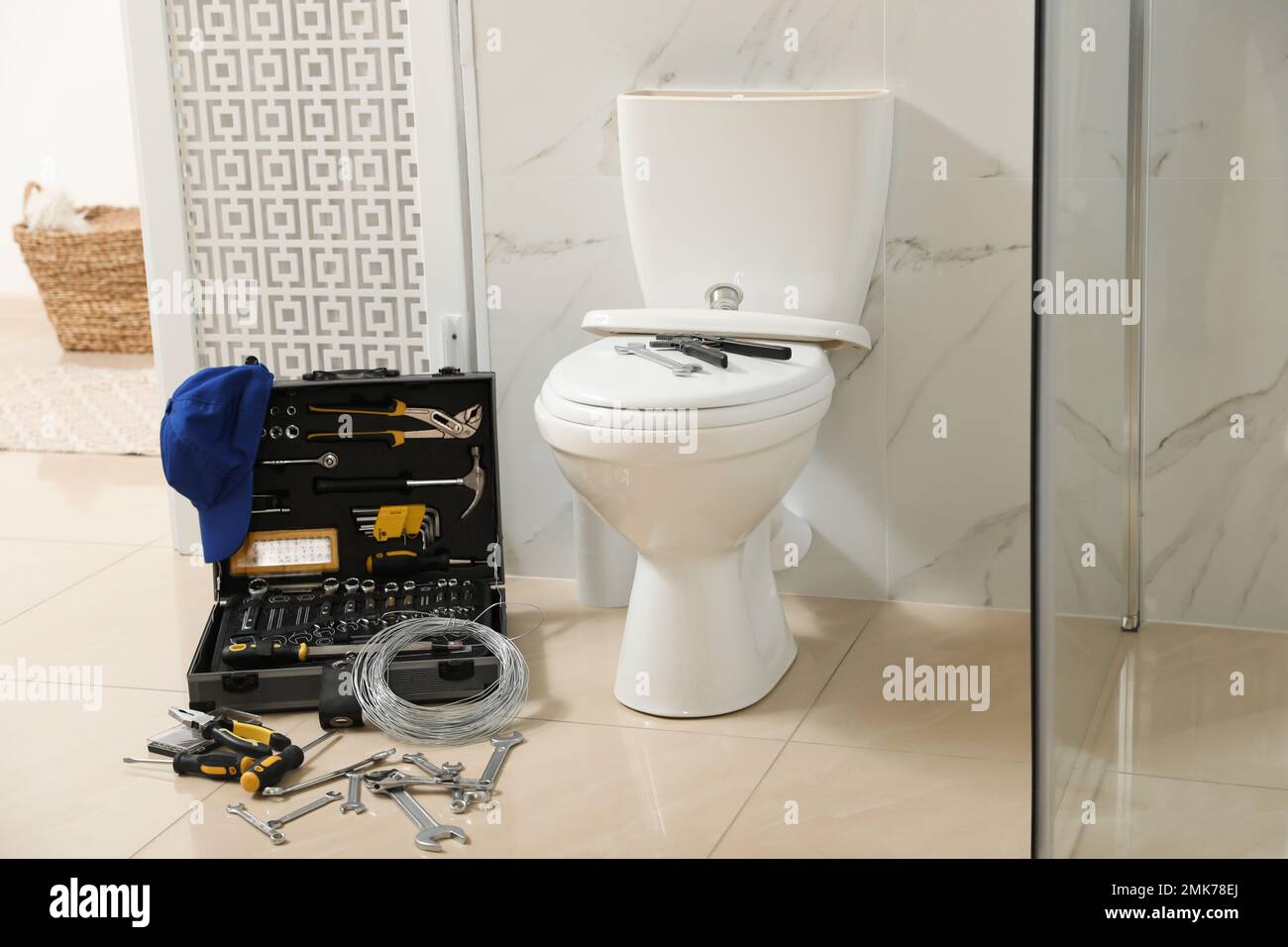 Plumber's tools near toilet bowl in bathroom Stock Photo - Alamy