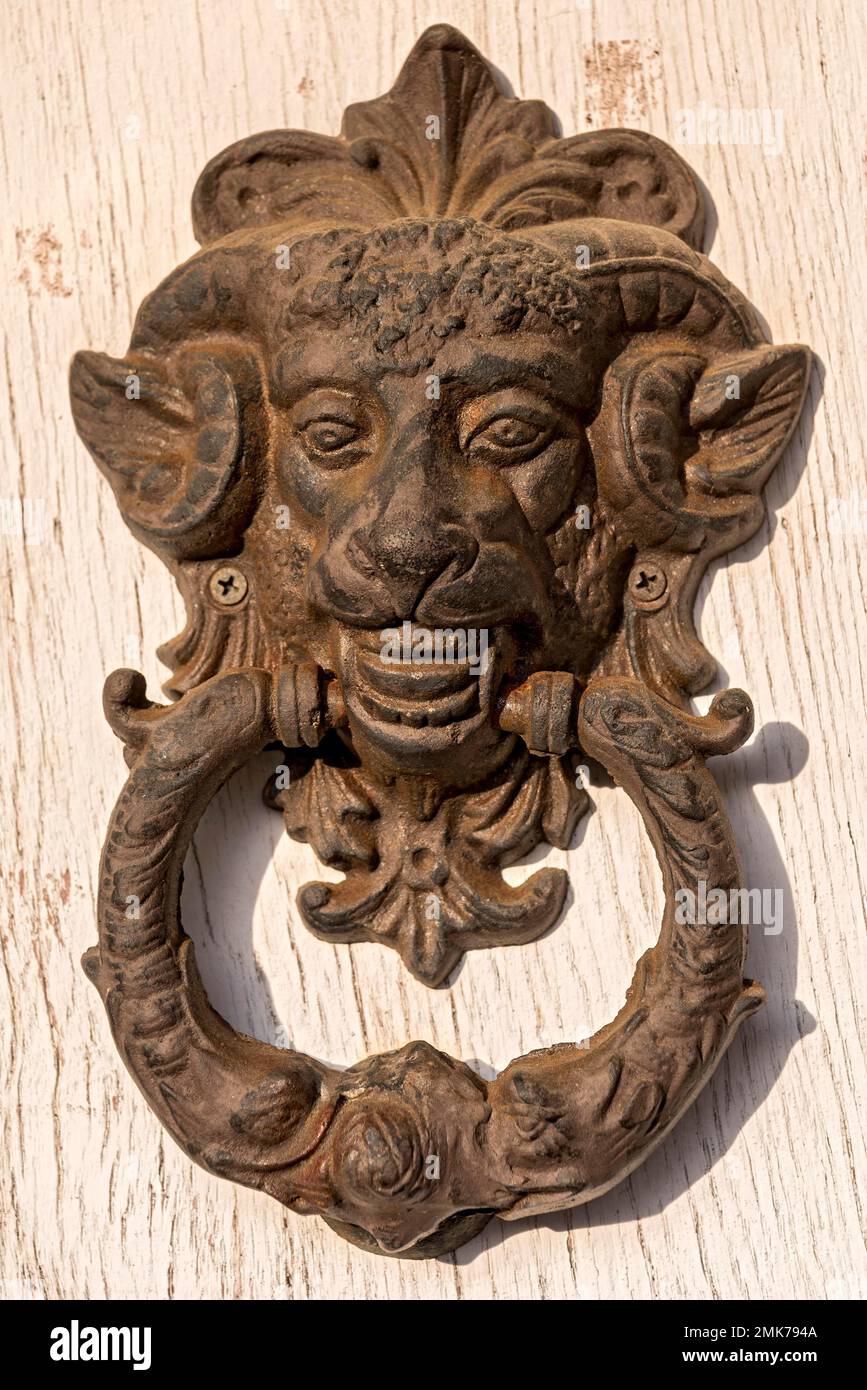 Rusty old iron door knocker, cast iron figure of a chimera, mixed ...
