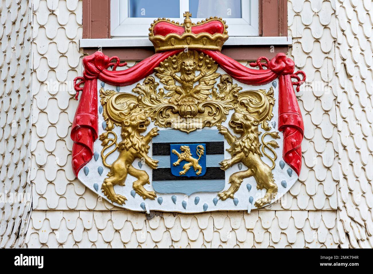 Wooden shingle-clad dwelling house and plastic Hessian coat of arms as ...