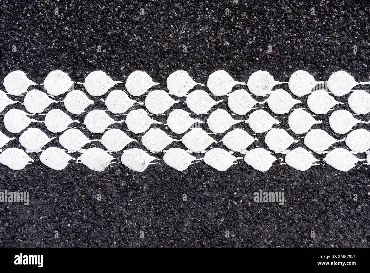 Rubbing strip or rumble strip of a road, white road marking with raised ...