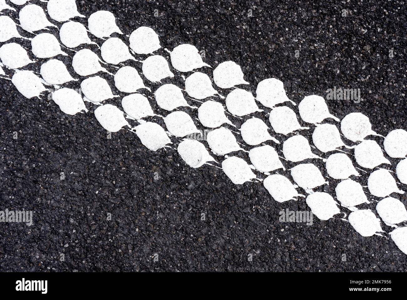 Rubbing strip or rumble strip of a road, white road marking with raised ...