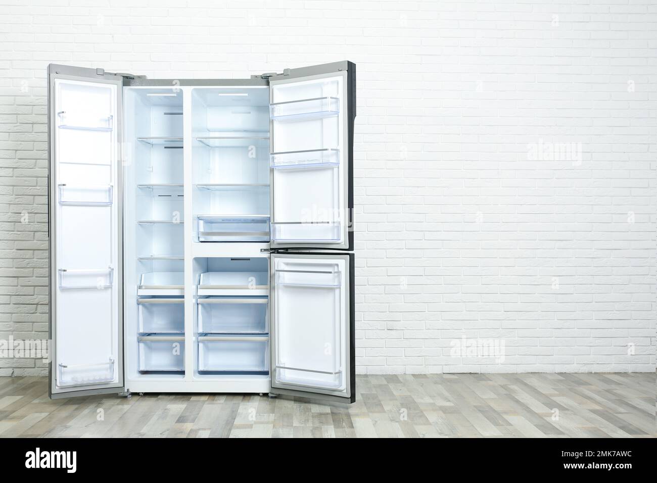 Modern empty refrigerator near white brick wall, space for text Stock ...
