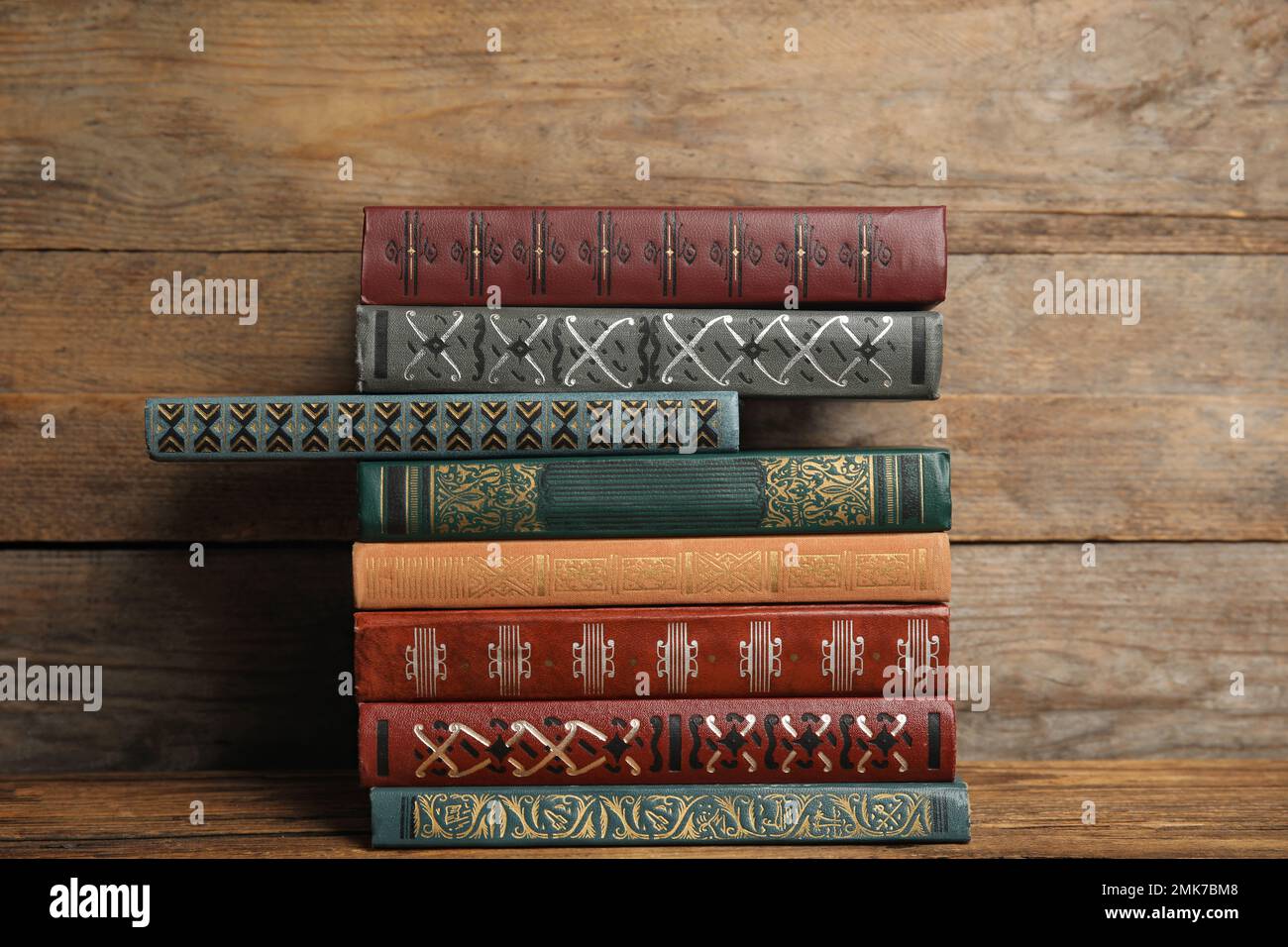 Collection of different books on table against wooden background Stock ...