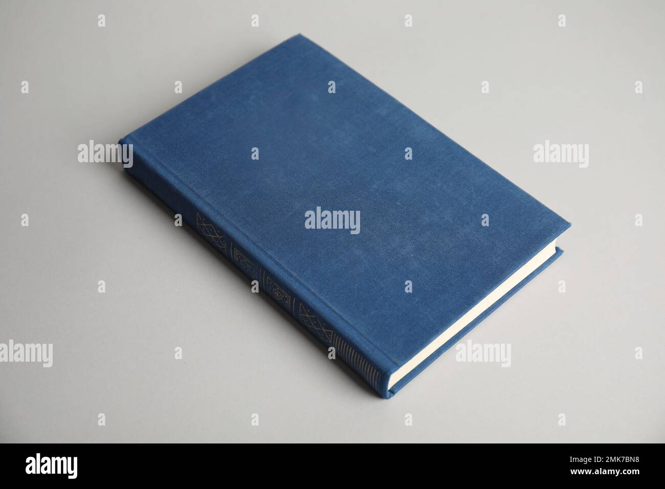 Hardcover book on light grey background. Space for design Stock Photo ...