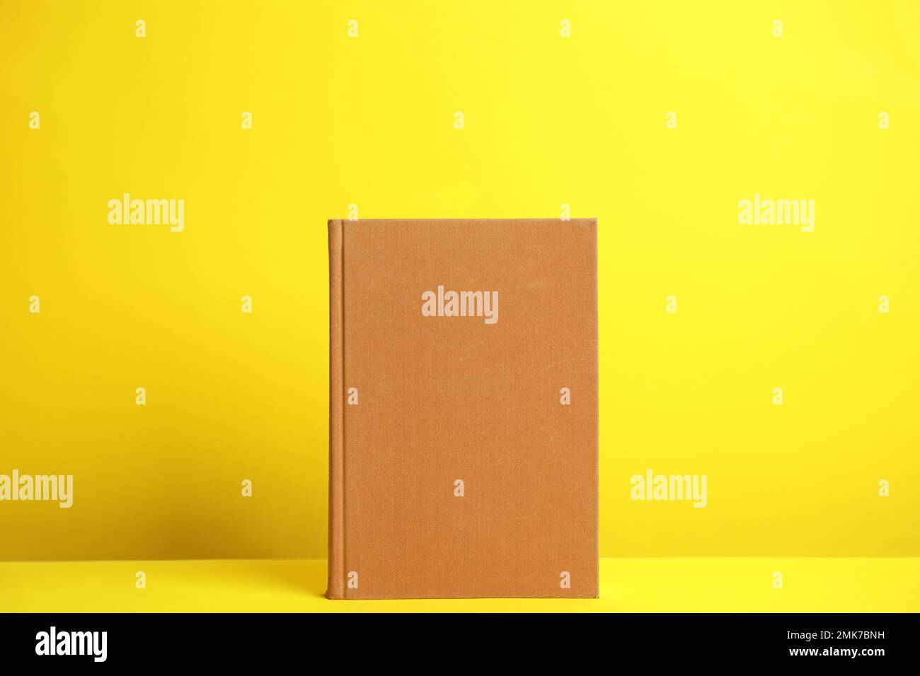 Hardcover book on yellow background. Space for design Stock Photo - Alamy