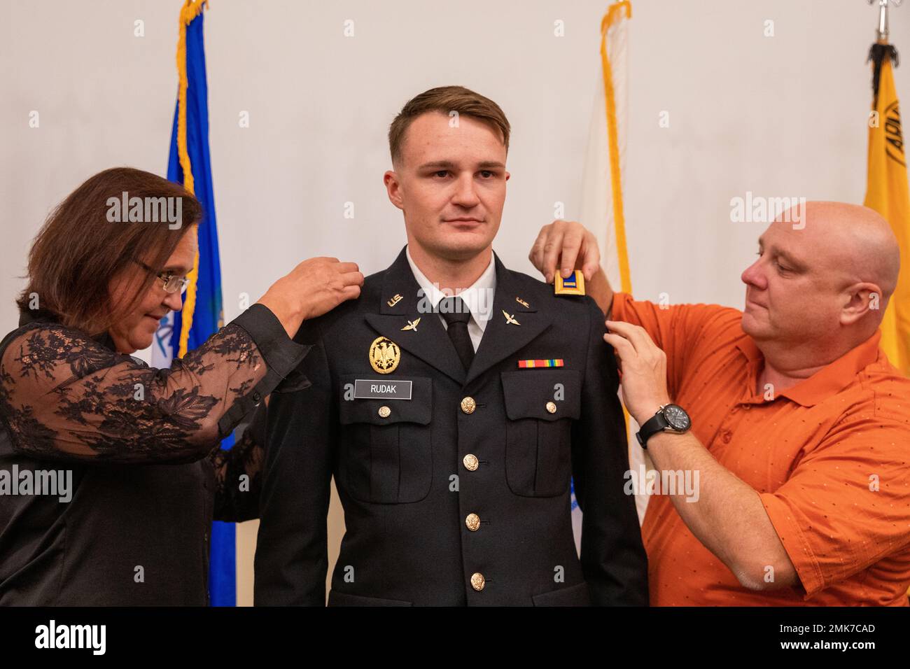 U.S. Army 2nd Lt. Phil Rudak stands at attention while his family ...