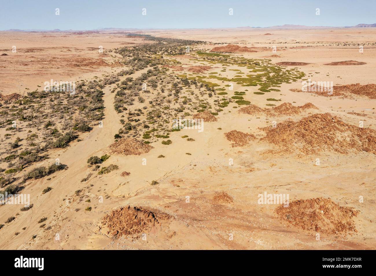 The dry bed of the Ugab river cuts through arid desert plains, aerial ...
