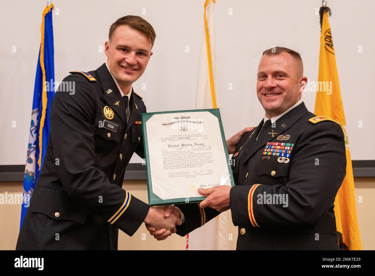 U.S. Army 2nd Lt. Phil Rudak, left, receives his appointment ...