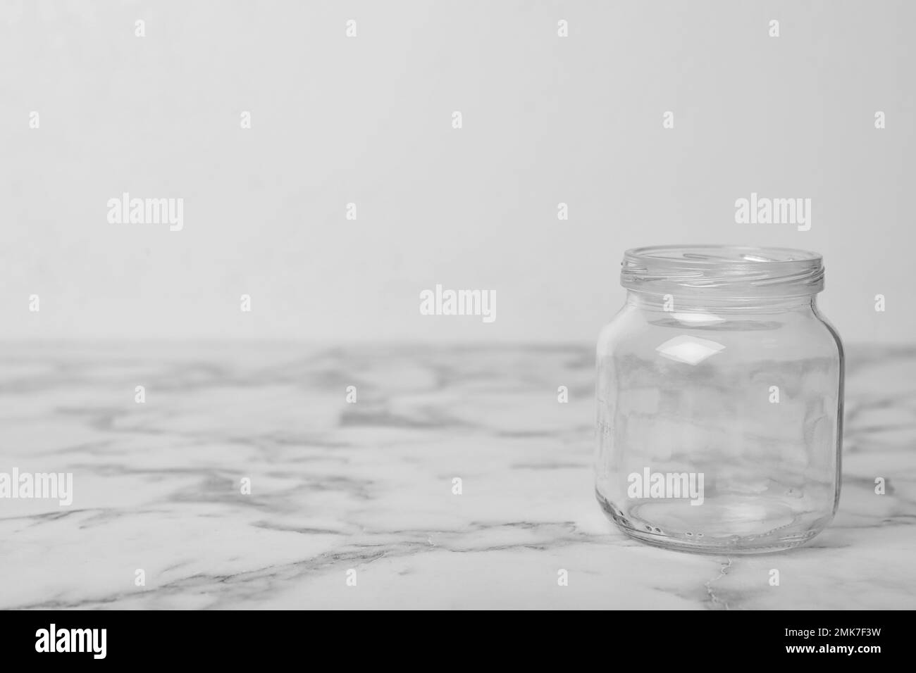 Empty glass jar on white marble table, space for text Stock Photo - Alamy