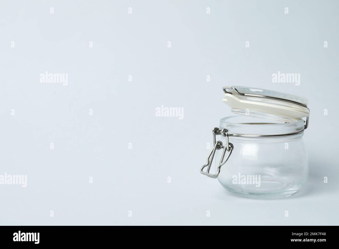 Open empty glass jar on light background, space for text Stock Photo ...