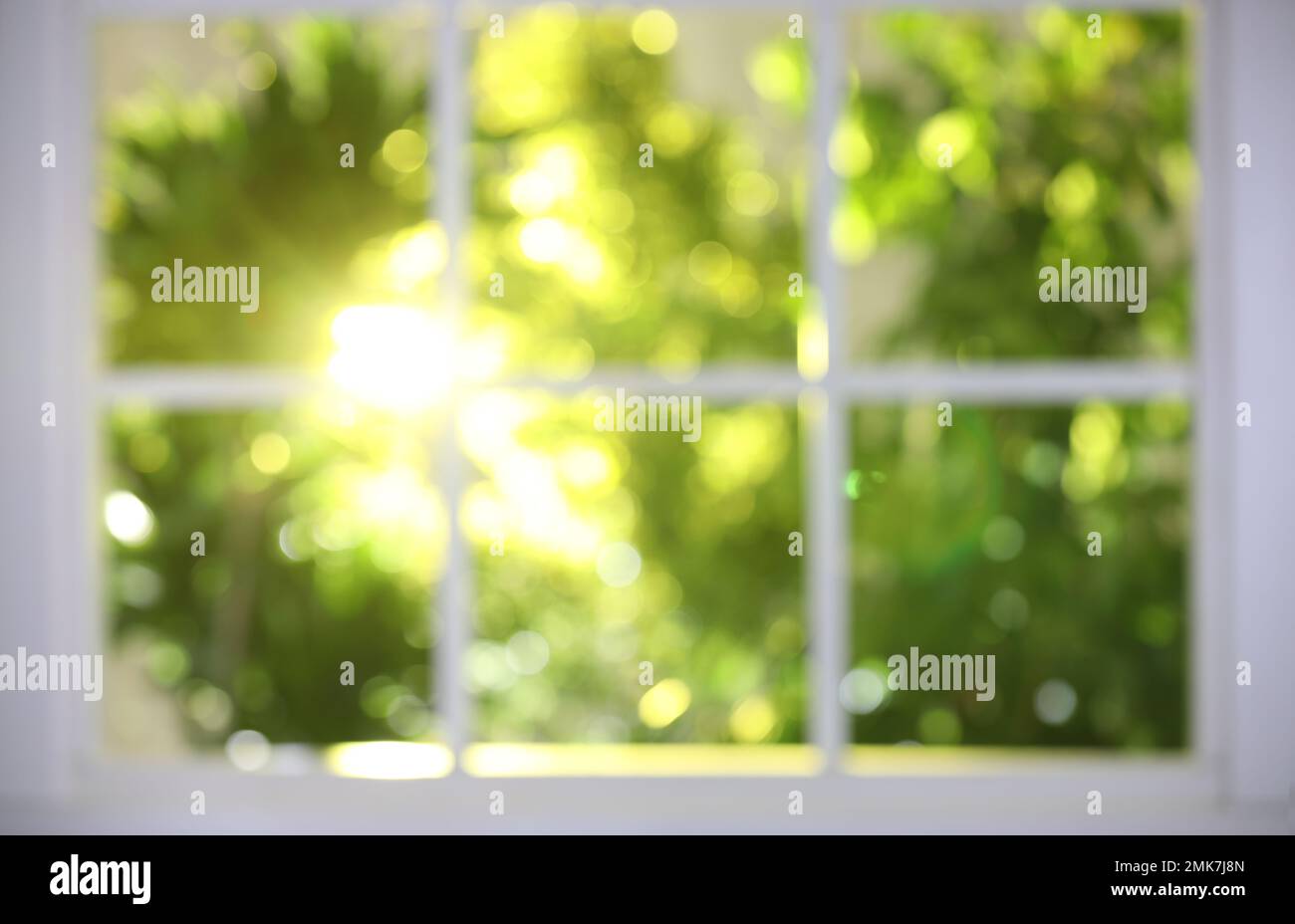 Blurred view through window on garden in morning Stock Photo - Alamy