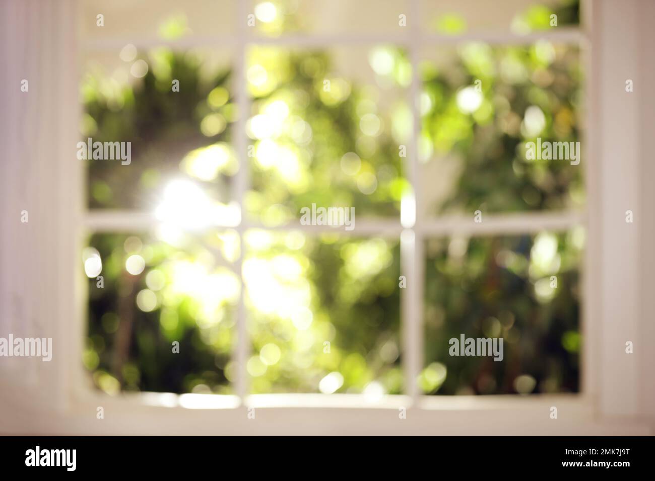 Blurred view through window on garden in morning Stock Photo - Alamy