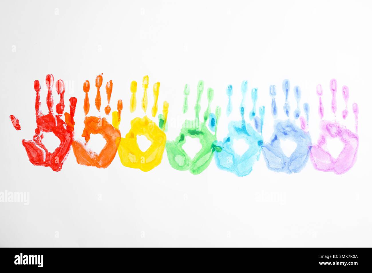 Handprints made with bright paints on white background, top view ...