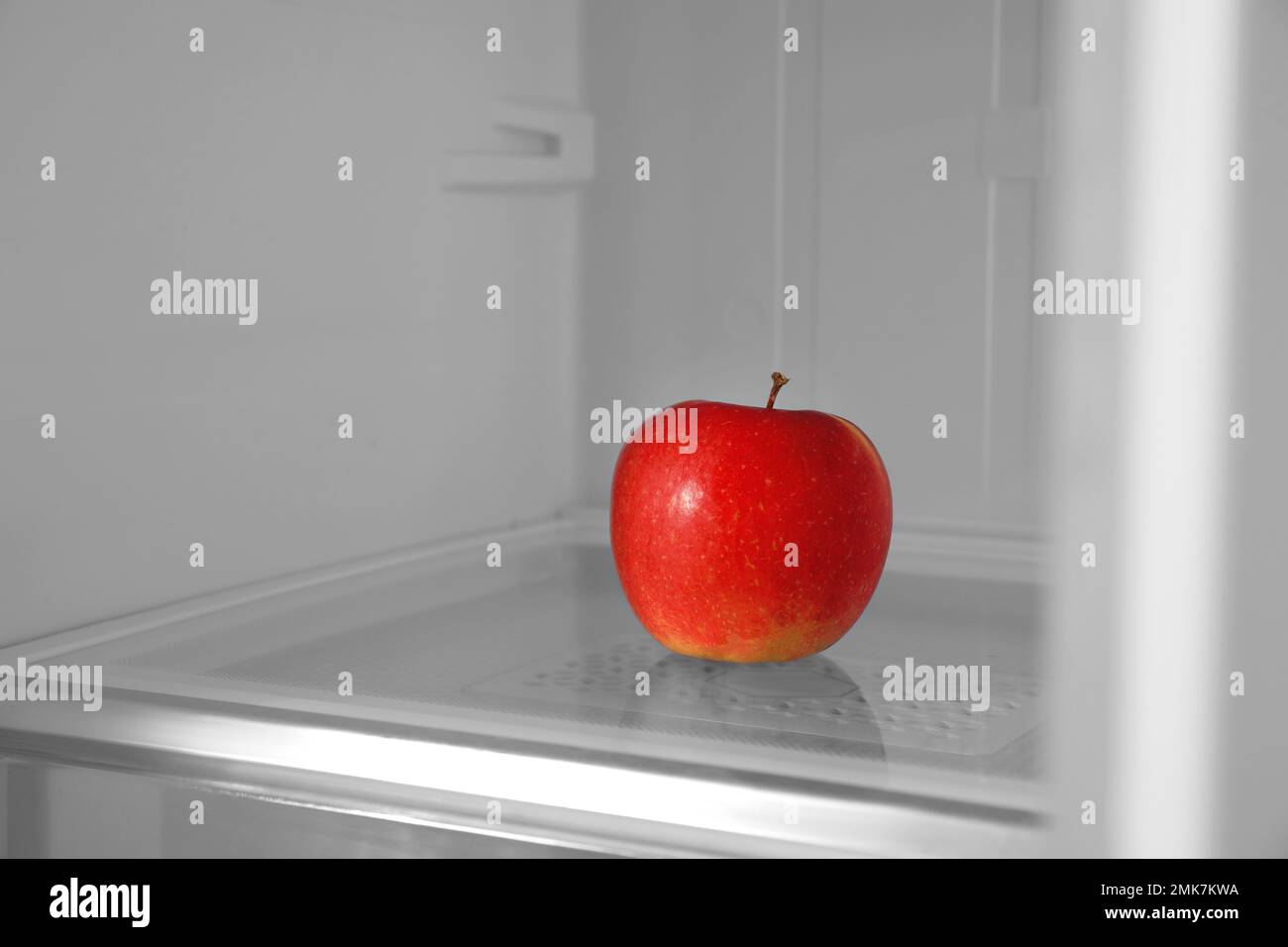 Red apple on shelf inside modern refrigerator Stock Photo - Alamy