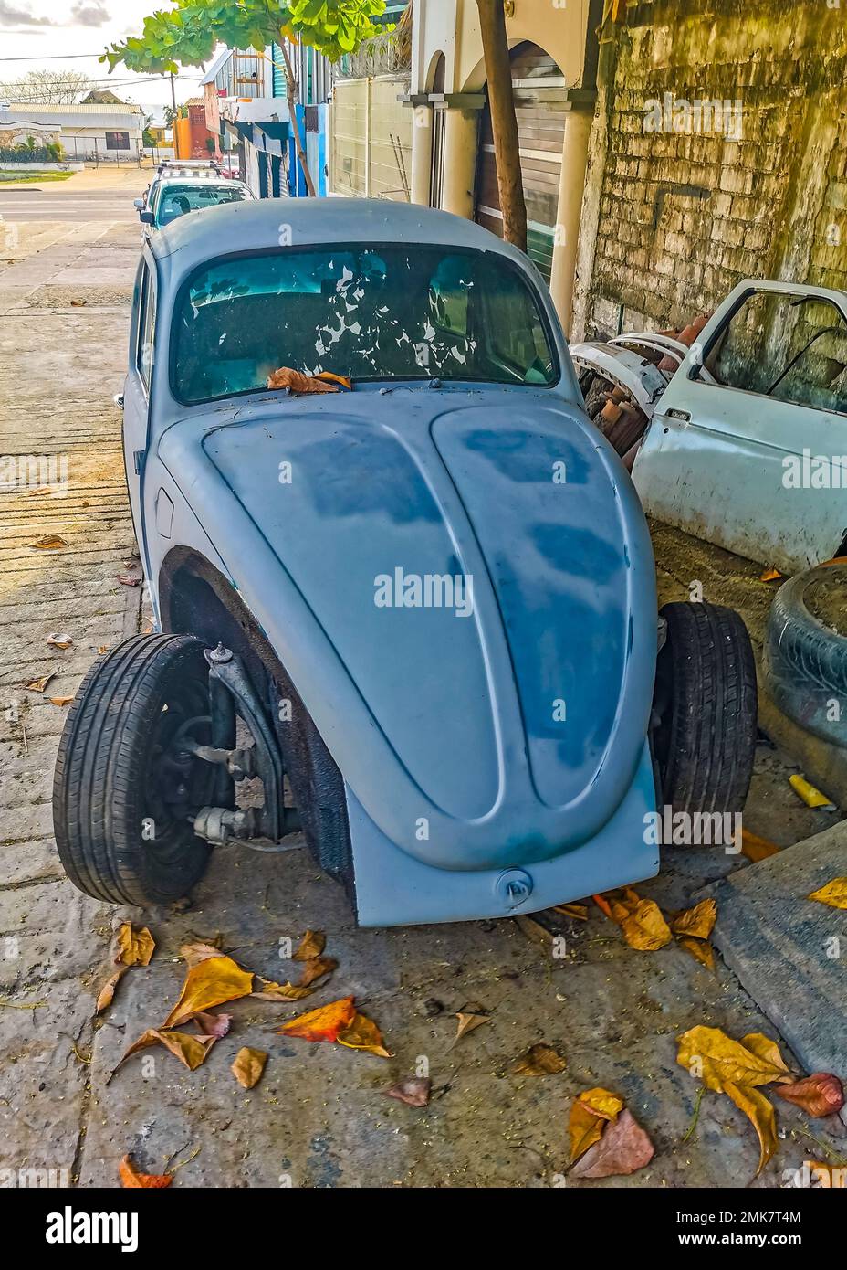 Various colorful old broken rusty and damaged cars and classic vintage ...
