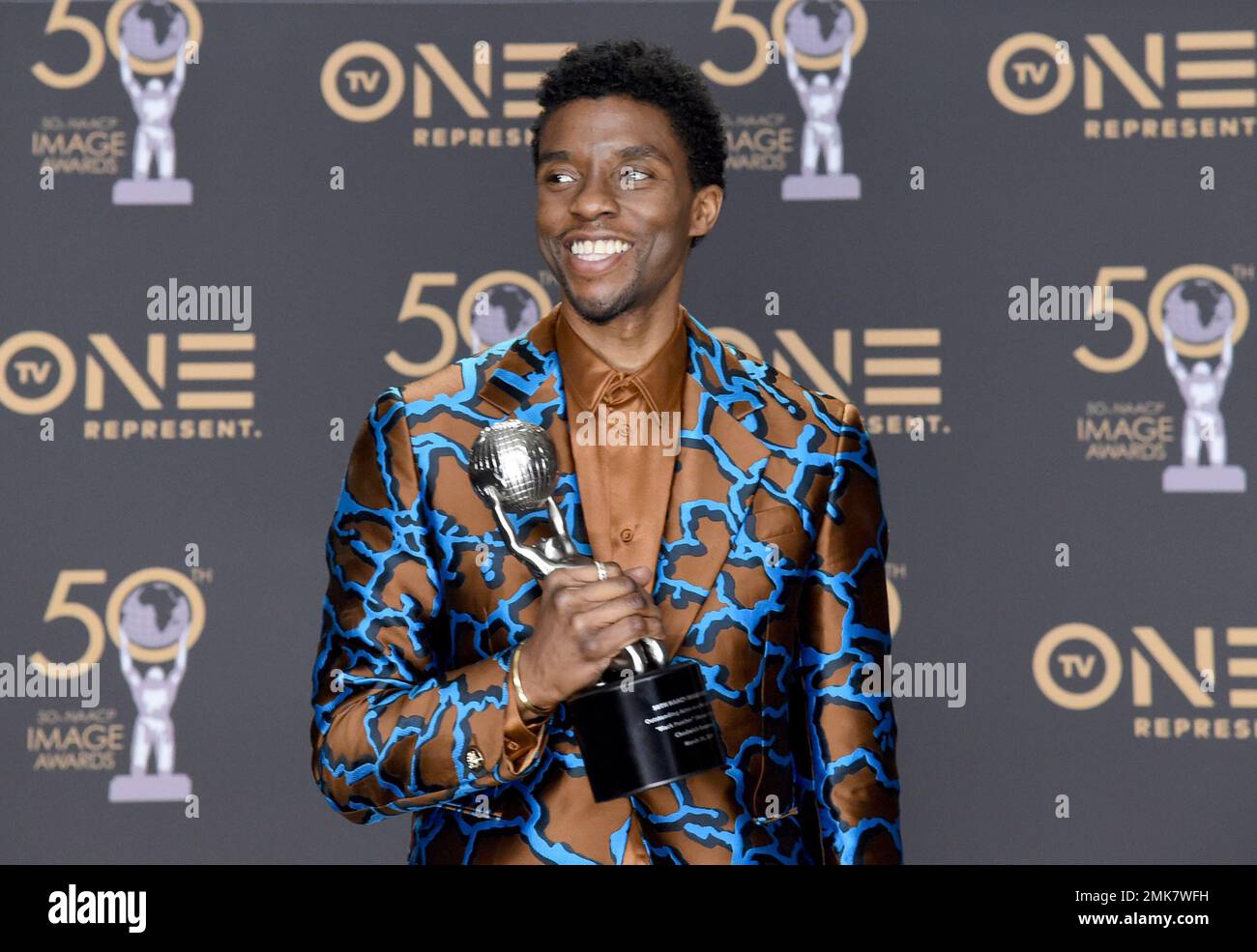 Chadwick Boseman poses in the press room with the award for outstanding ...